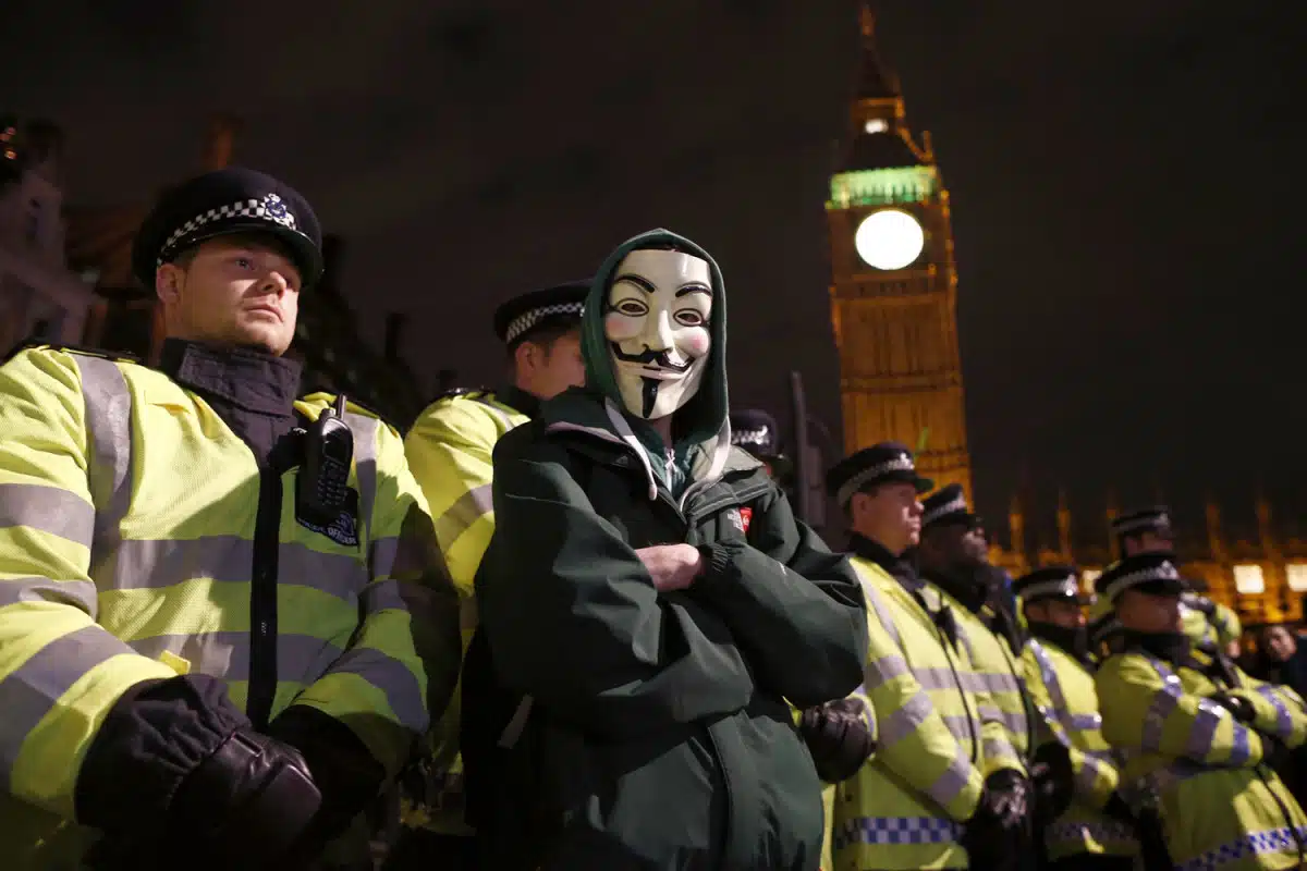 Hacktivist Group 'Anonymous' March On London, Torch Police Car And ...